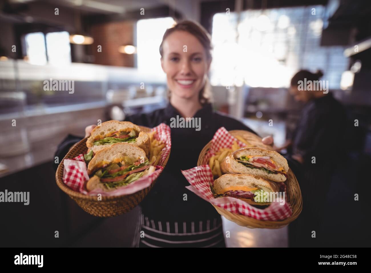 Portrait waitress serving burger hi-res stock photography and images ...