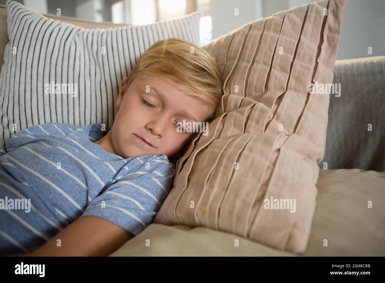 Boy sleeping on sofa in the living room Stock Photo - Alamy