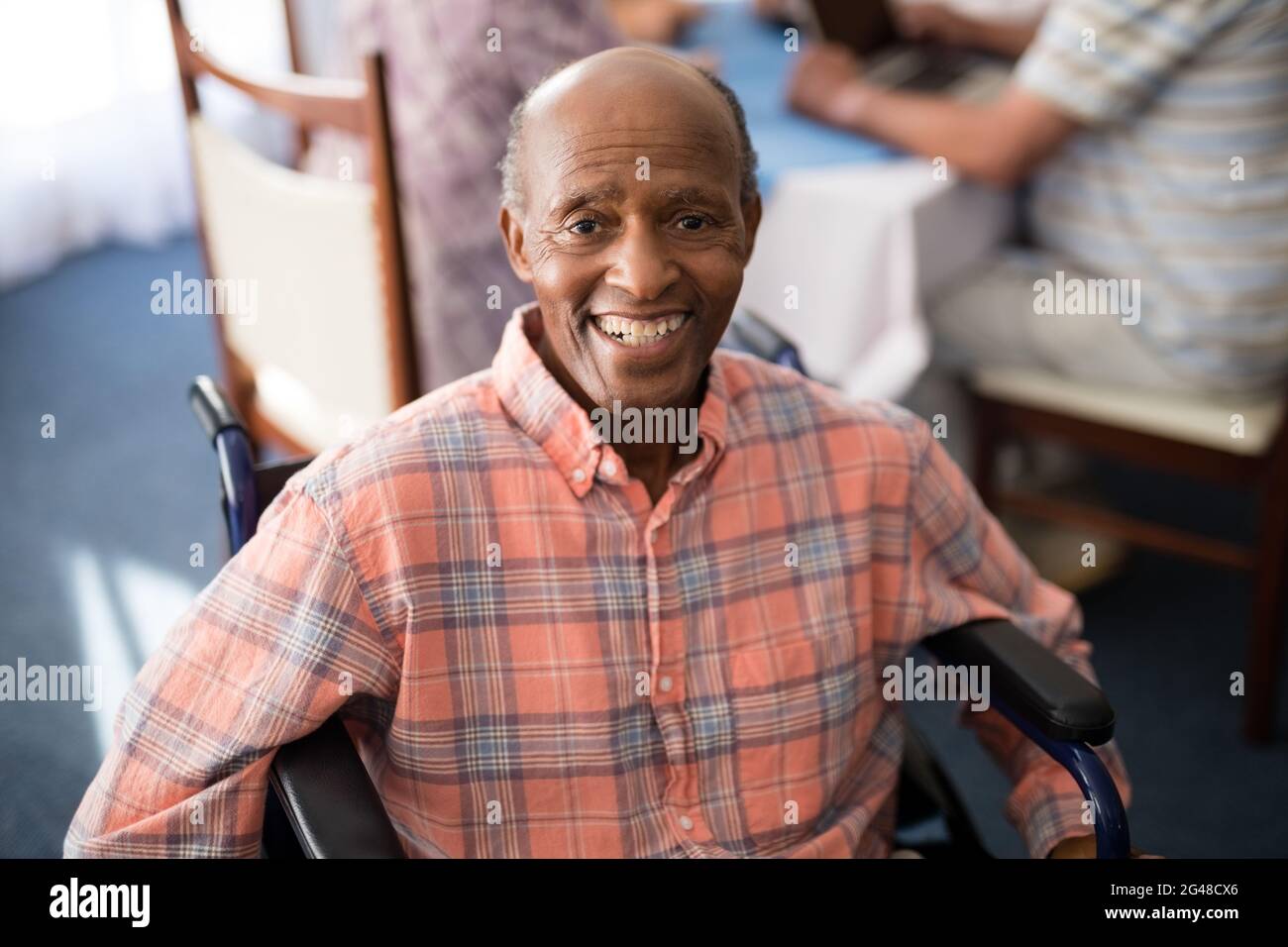 Portrait of smiling disabled senior man sitting on wheelchair Stock ...