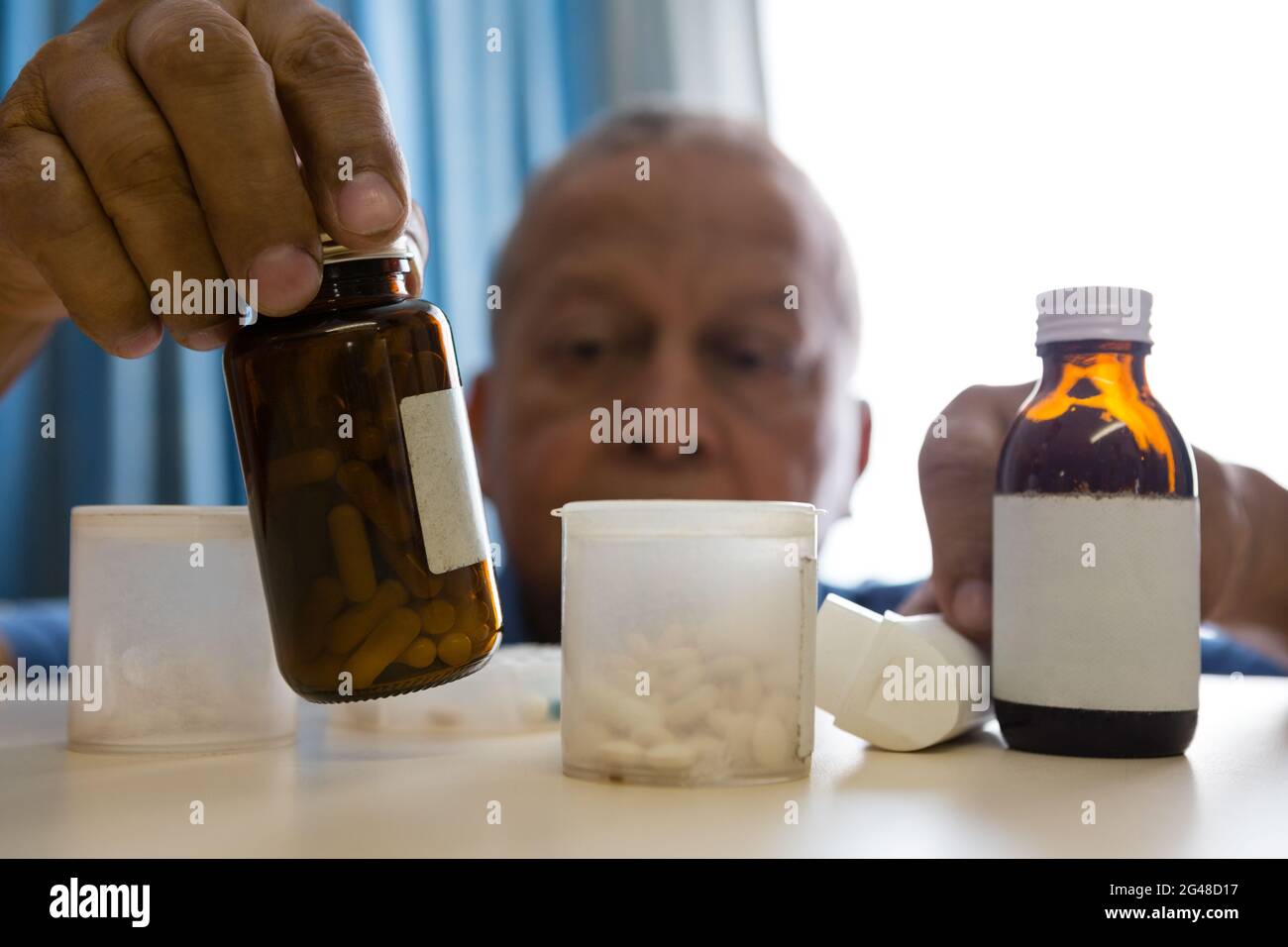 Senior man taking medicines hi-res stock photography and images - Alamy