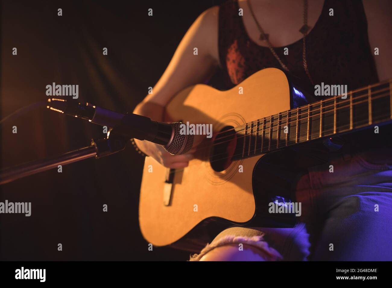 Female guitarist performing in music concert Stock Photo - Alamy