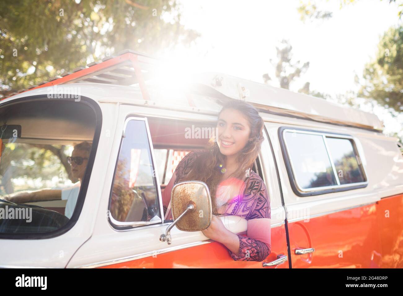Woman leaning on camper van window Stock Photo - Alamy