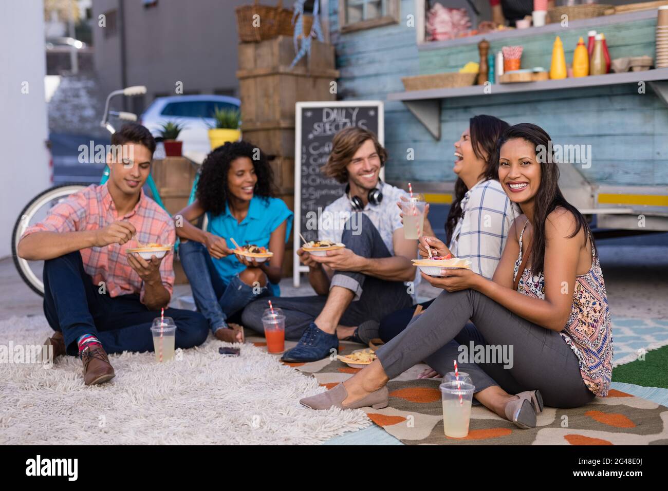 Friends interacting while having snacks and juice Stock Photo - Alamy