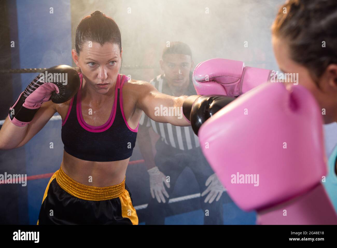Female athletes fighting in boxing ring Stock Photo - Alamy