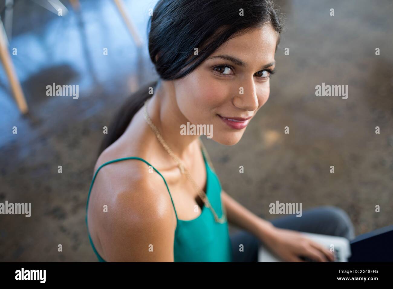 Female executive using laptop in office Stock Photo - Alamy