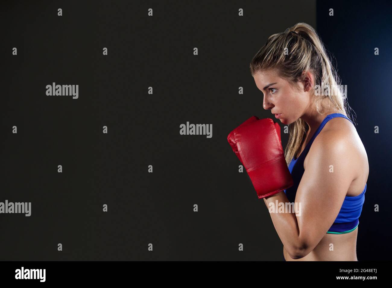 Woman practicing boxing in fitness studio Stock Photo - Alamy
