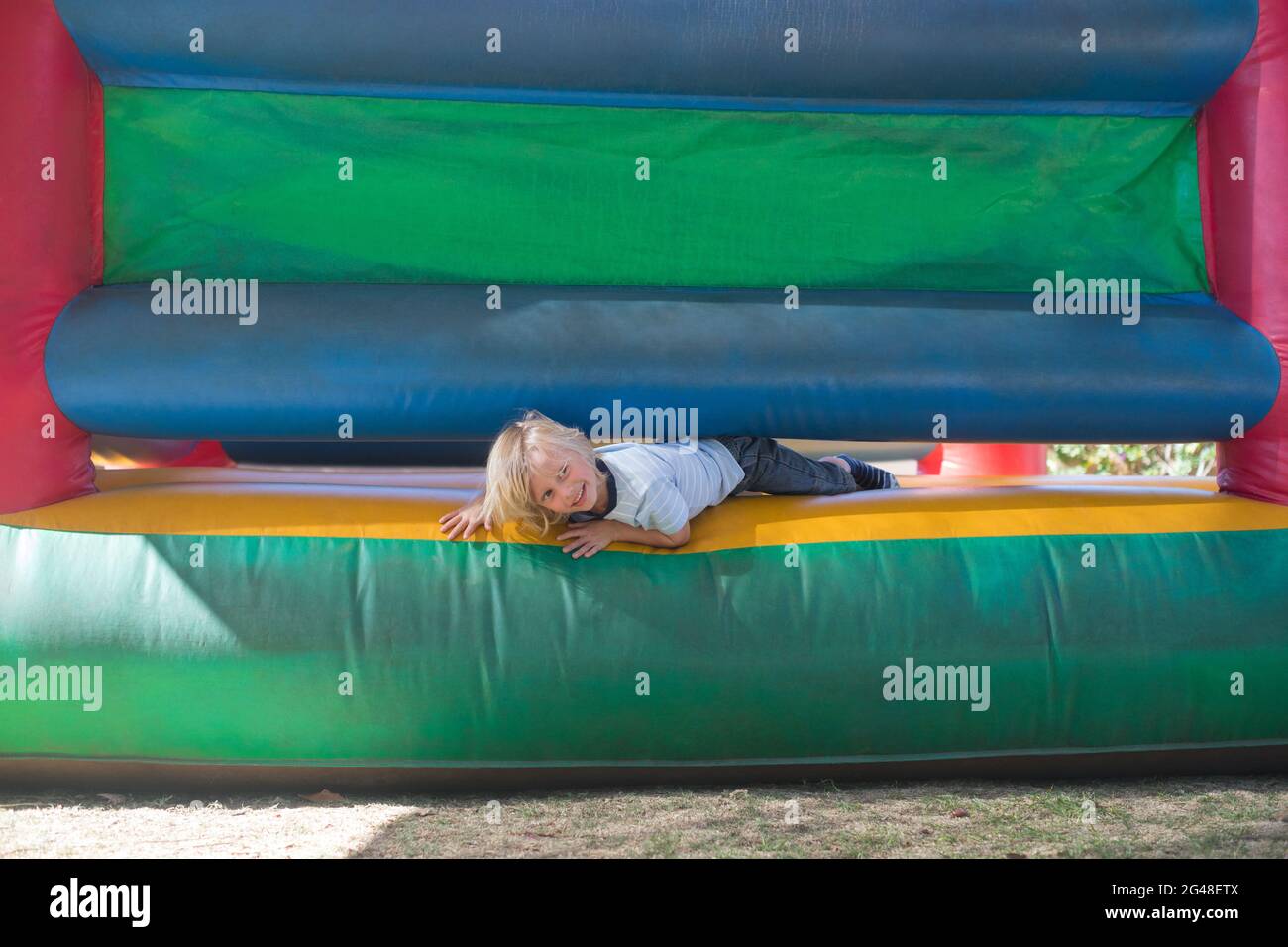 Portrait of happy boy playing on bouncy castle Stock Photo - Alamy