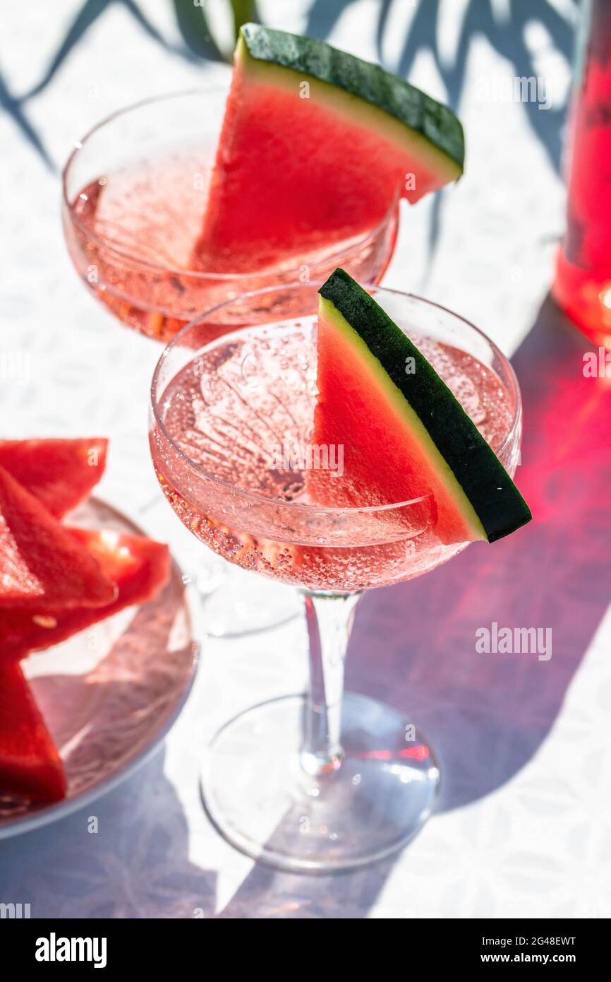 Bubbly cava cocktail garnished with slides of watermelon Stock Photo ...