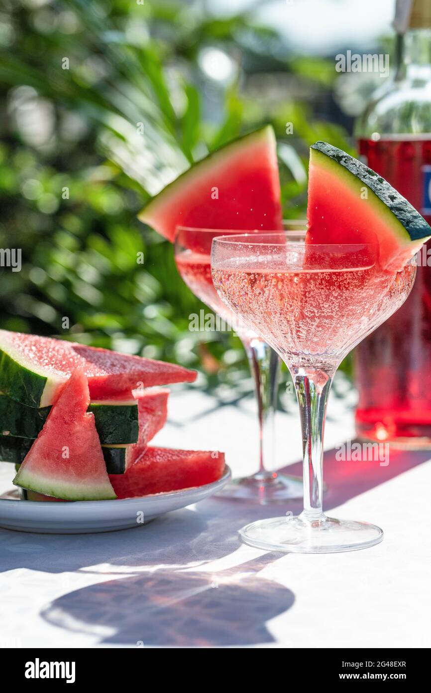 Bubbly cava cocktail garnished with slides of watermelon Stock Photo ...