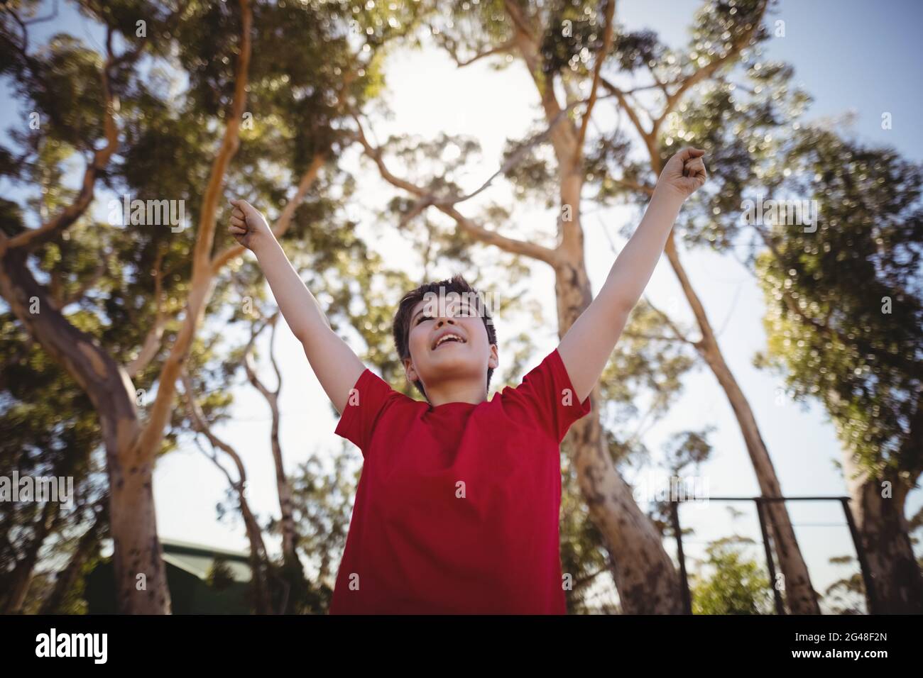 Boy cheering during obstacle course Stock Photo - Alamy