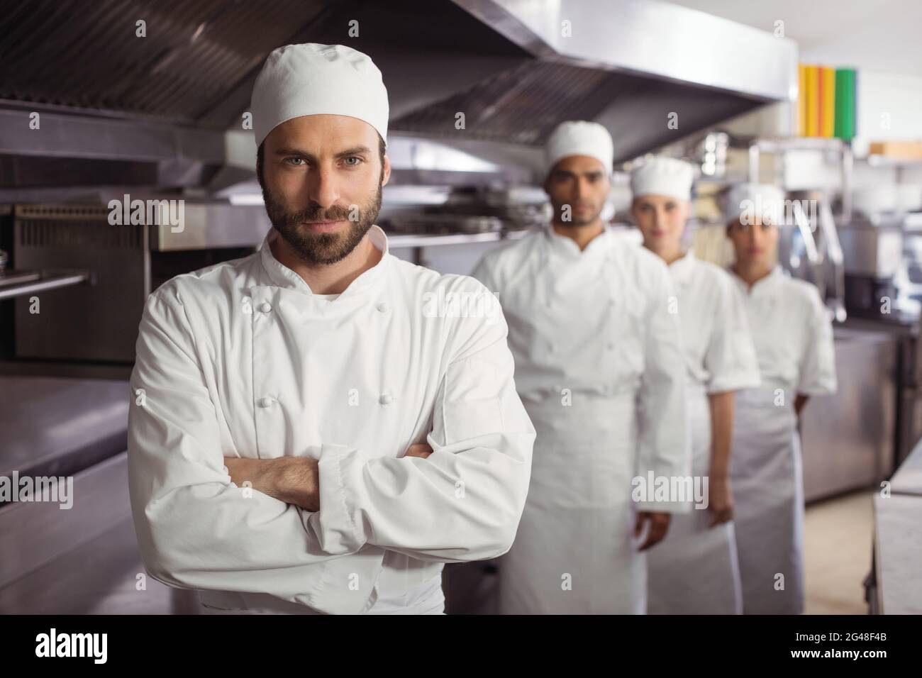 Happy chefs team standing together in commercial kitchen Stock Photo ...