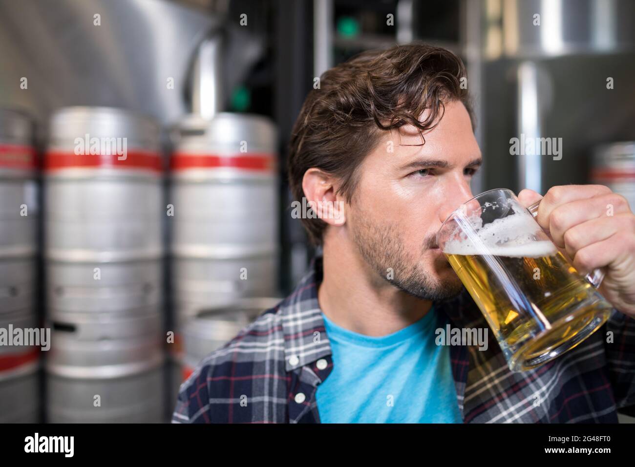 Worker tasting beer Stock Photo - Alamy