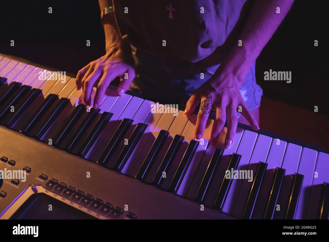 Female musician playing piano while performing in concert Stock Photo ...