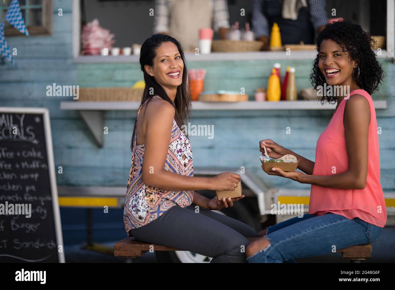 Happy friends having snacks Stock Photo - Alamy