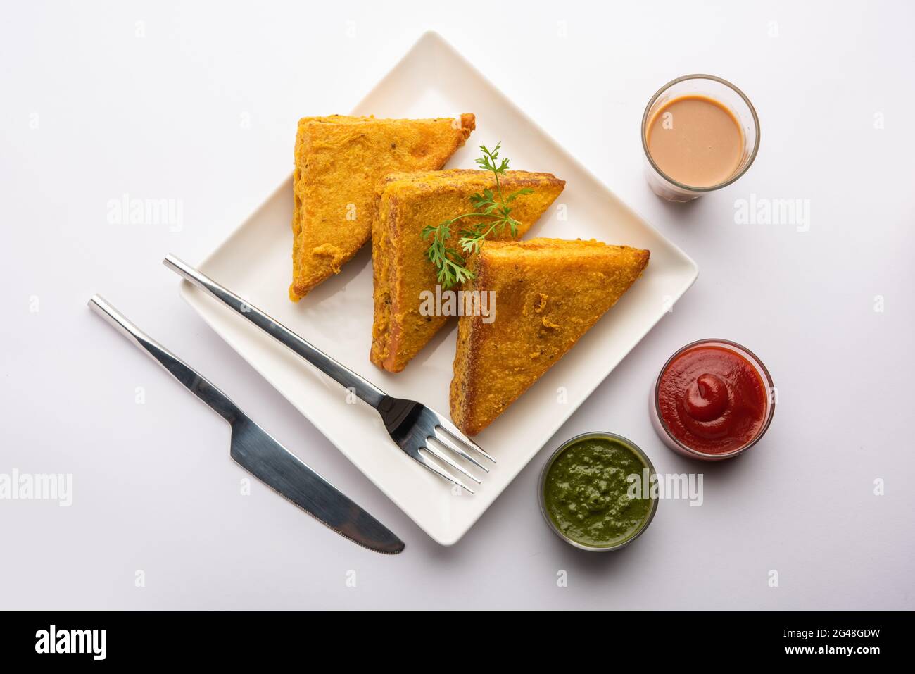 Sandwich Bread Pakora or triangle shape pakoda served with tomato ...