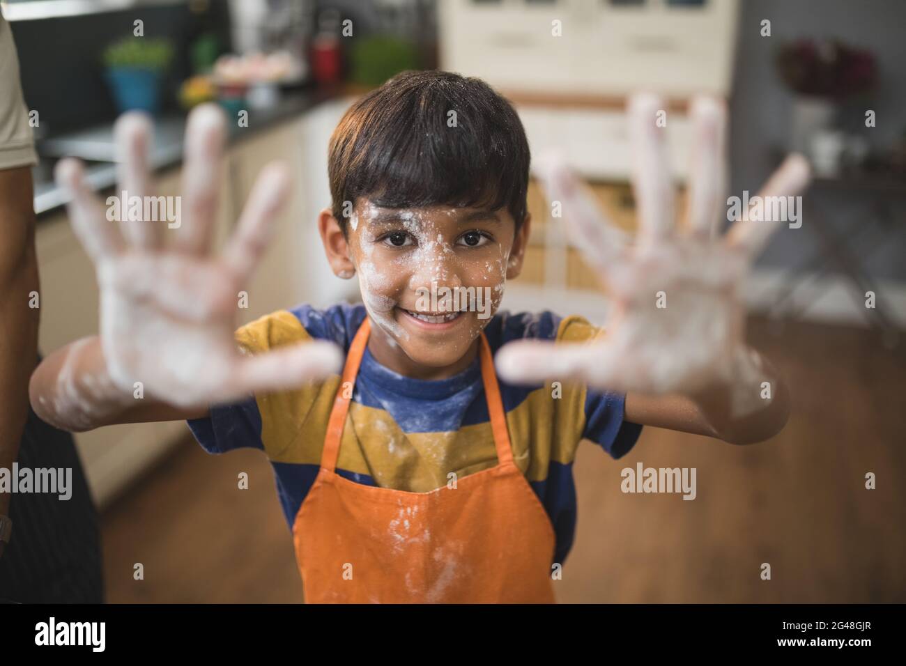 Portrait of smiling boy showing messy palms in kitchen Stock Photo - Alamy