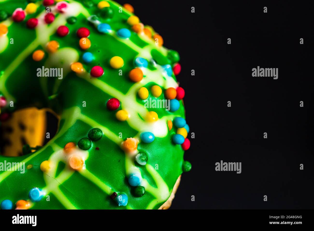 Green glazed donut with sprinkles isolated. Close up of colorful donut Stock Photo - Alamy