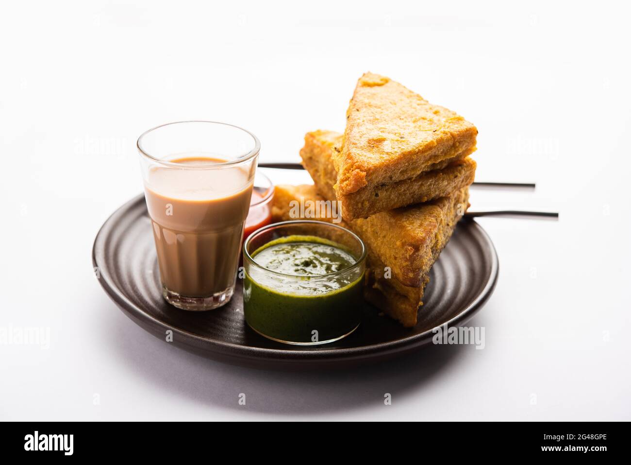 Sandwich Bread Pakora or triangle shape pakoda served with tomato ...
