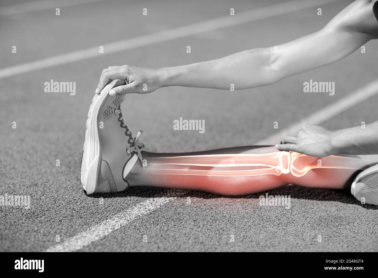 Low section of athlete stretching on sports track Stock Photo - Alamy