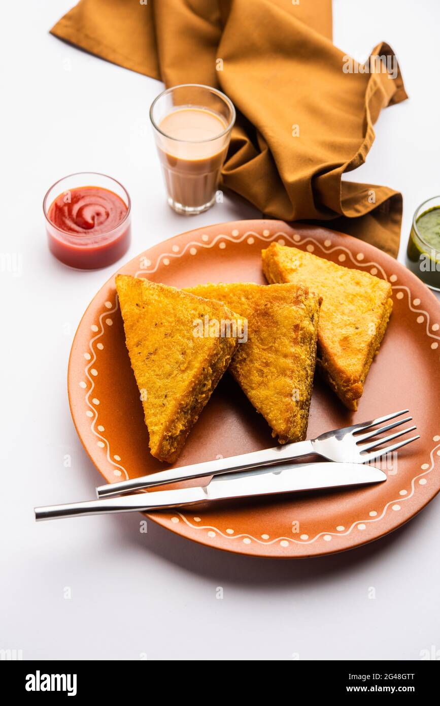 Sandwich Bread Pakora or triangle shape pakoda served with tomato ...