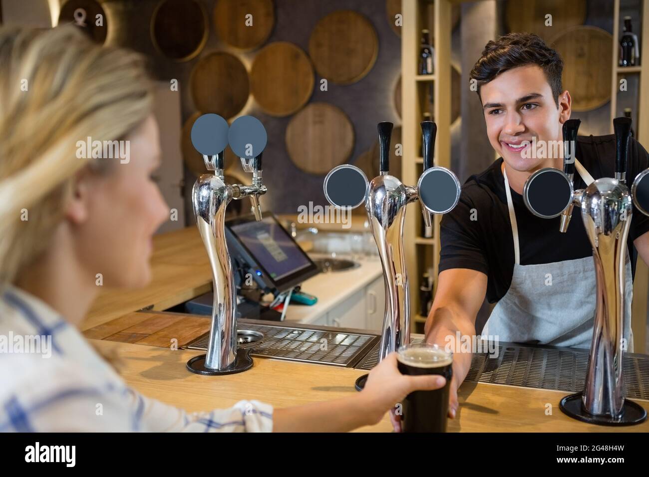 Bartender serving two hi-res stock photography and images - Alamy
