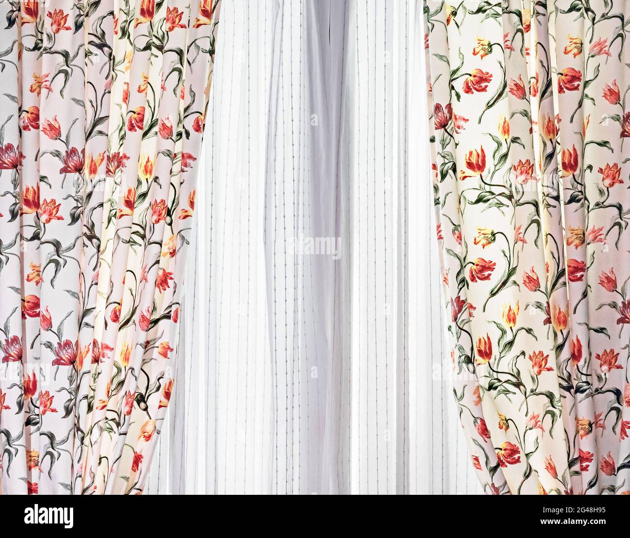 Double-layer curtains in fabric with floral pattern and white tulle ...