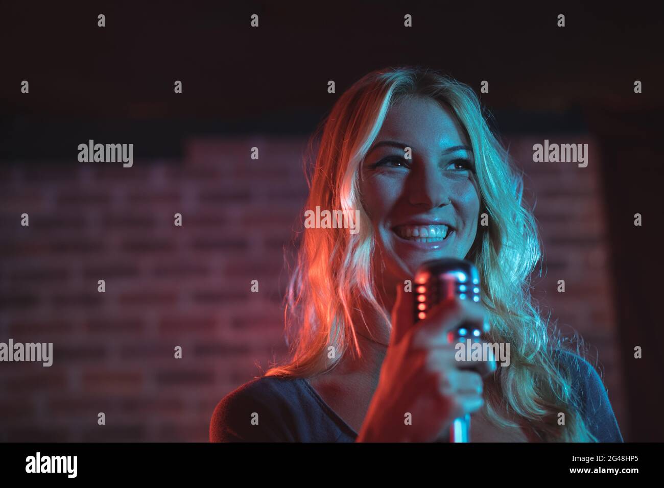 Female singer performing at music concert Stock Photo - Alamy