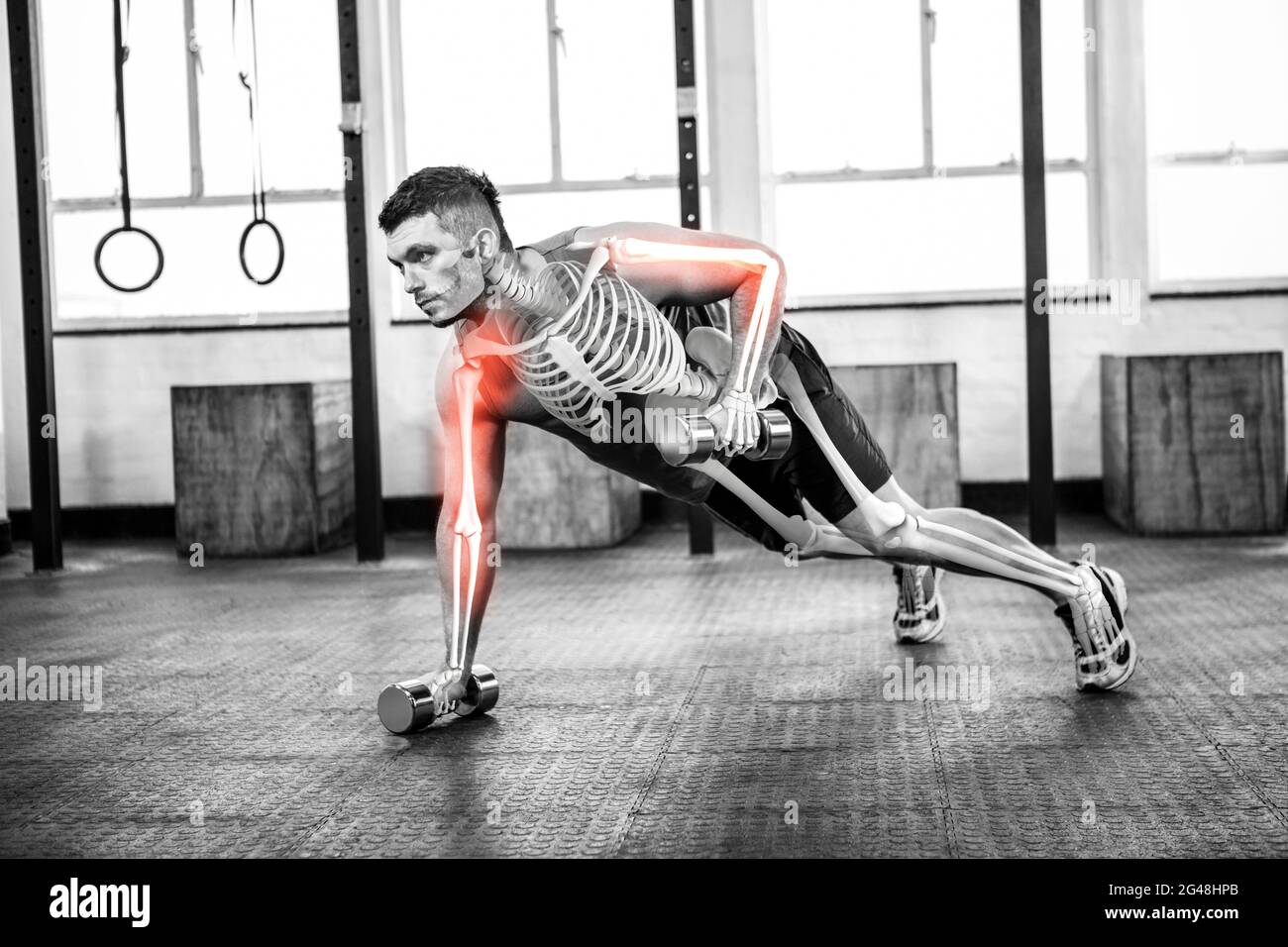 Highlighted body of strong man lifting weights at gym Stock Photo - Alamy