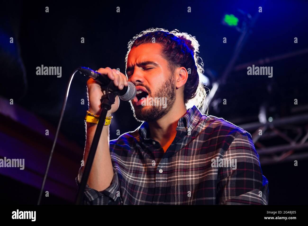 Man singing on microphone Stock Photo - Alamy