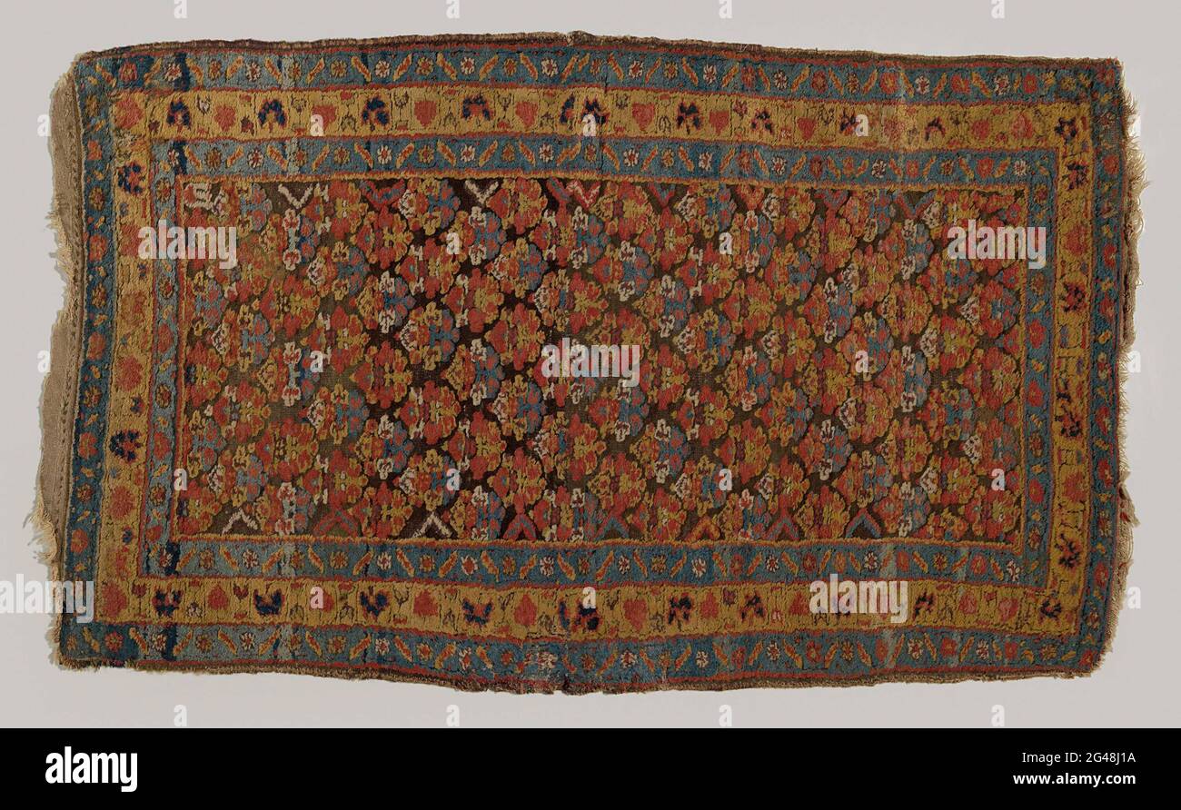 Floral rug with diagonally placed flowers in blue and mustard yellow on ...