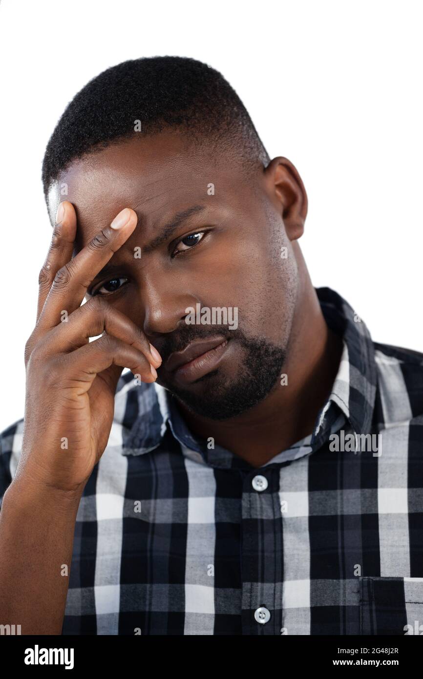 Tensed man against white background Stock Photo - Alamy