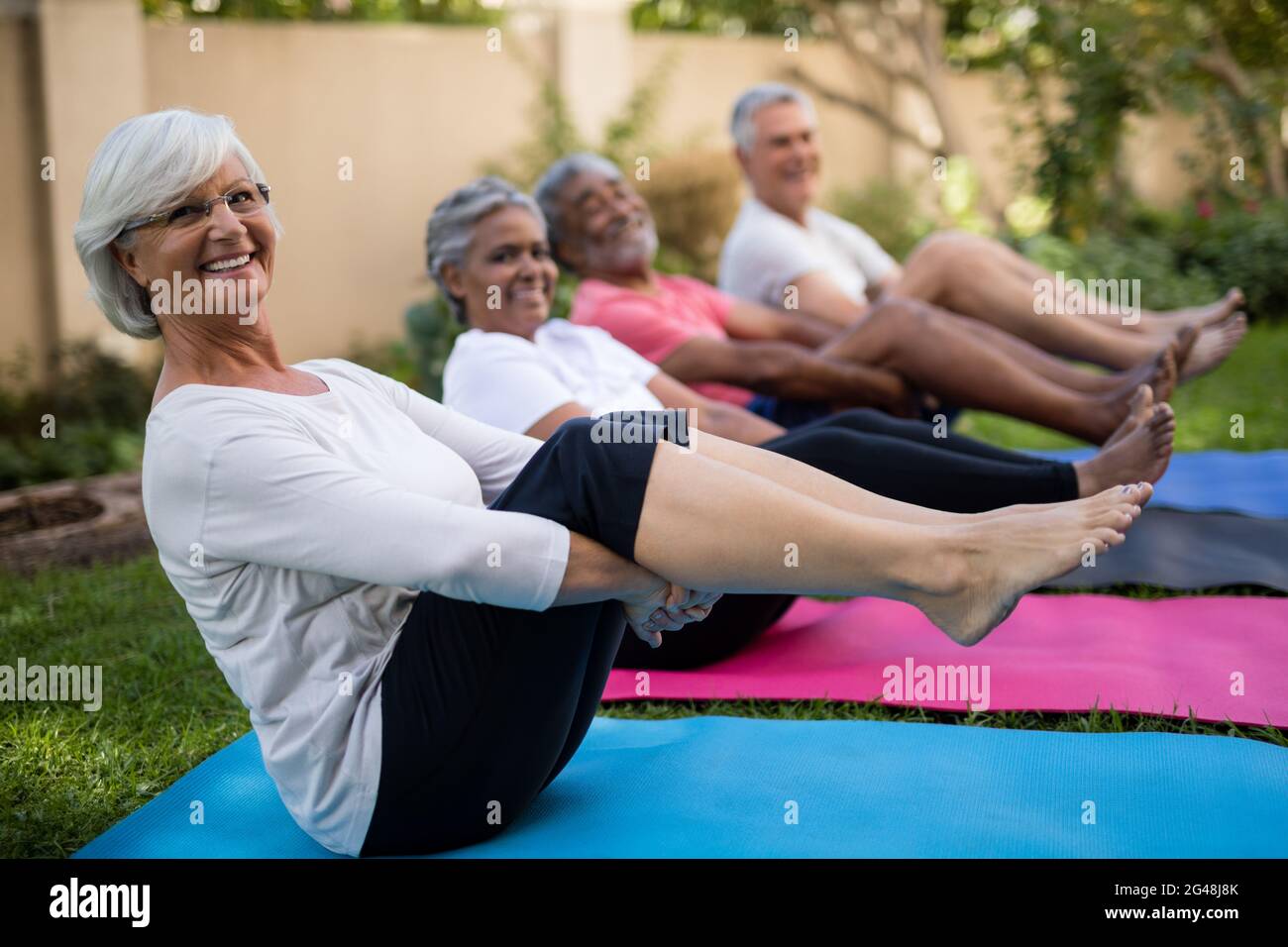Smiling senior people exercising with feet up Stock Photo - Alamy