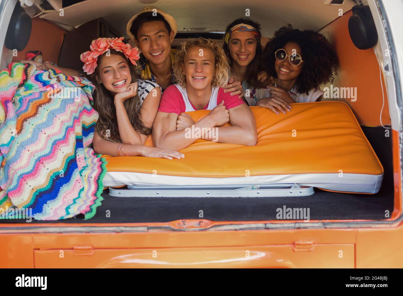 Portrait of smiling friends in camper van Stock Photo - Alamy