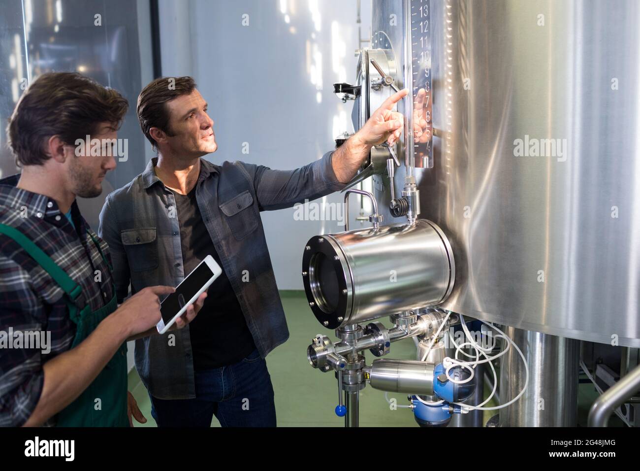 Worker explaining coworker using hi-res stock photography and images ...