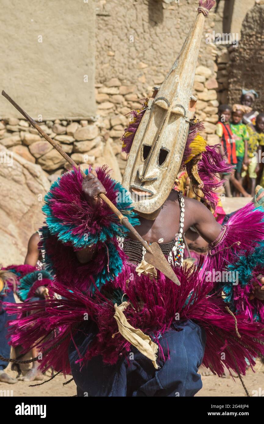 Dogon dancers performing the Dama ritual dance wearing Kanaga masks ...
