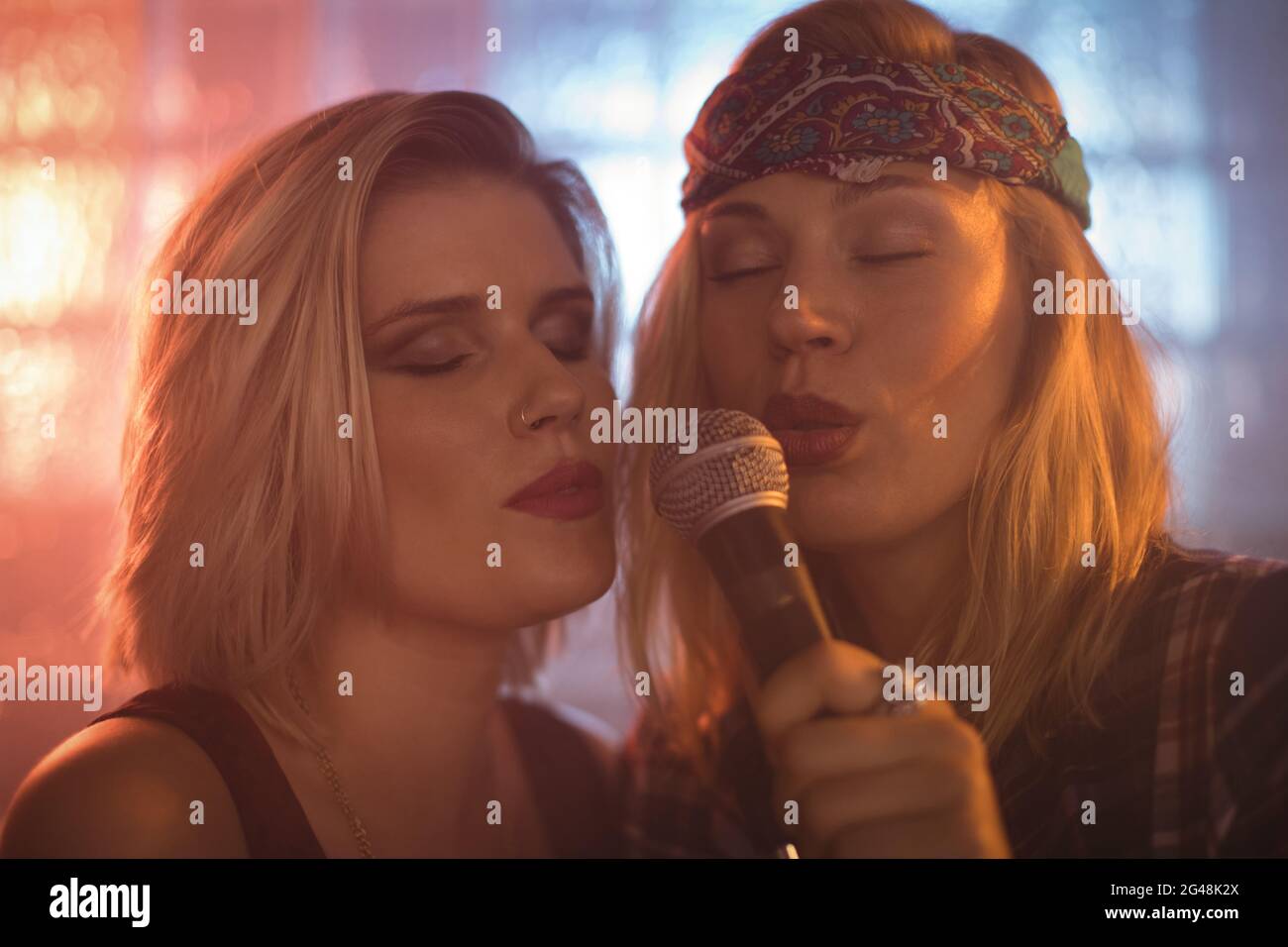 Beautiful female singers performing in nightclub Stock Photo - Alamy