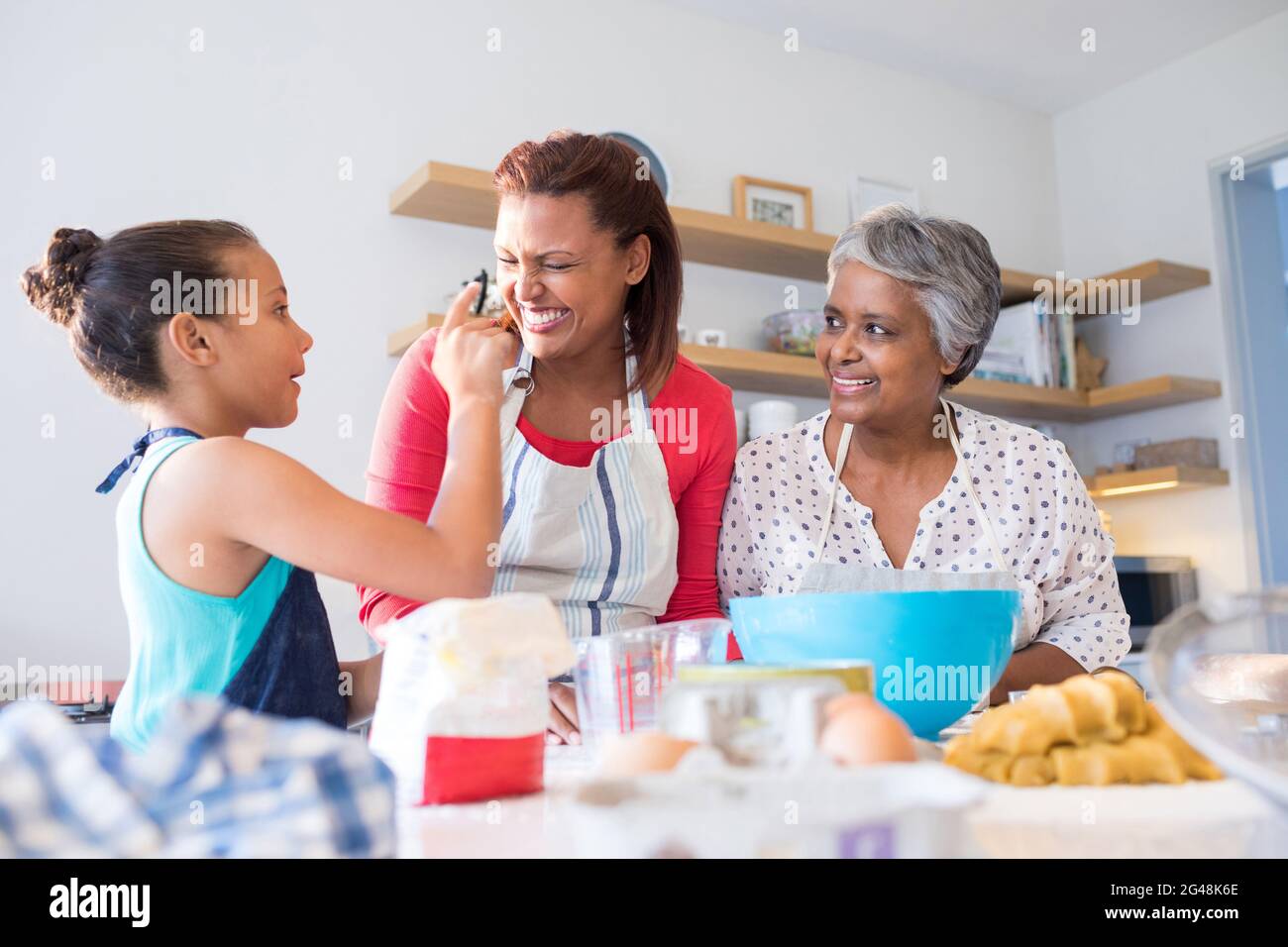 Happy family having fun in kitchen Stock Photo - Alamy
