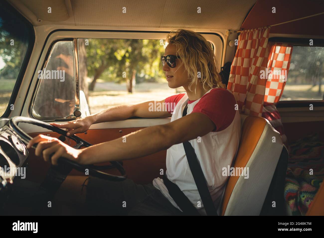 Side view of man driving camper van Stock Photo - Alamy
