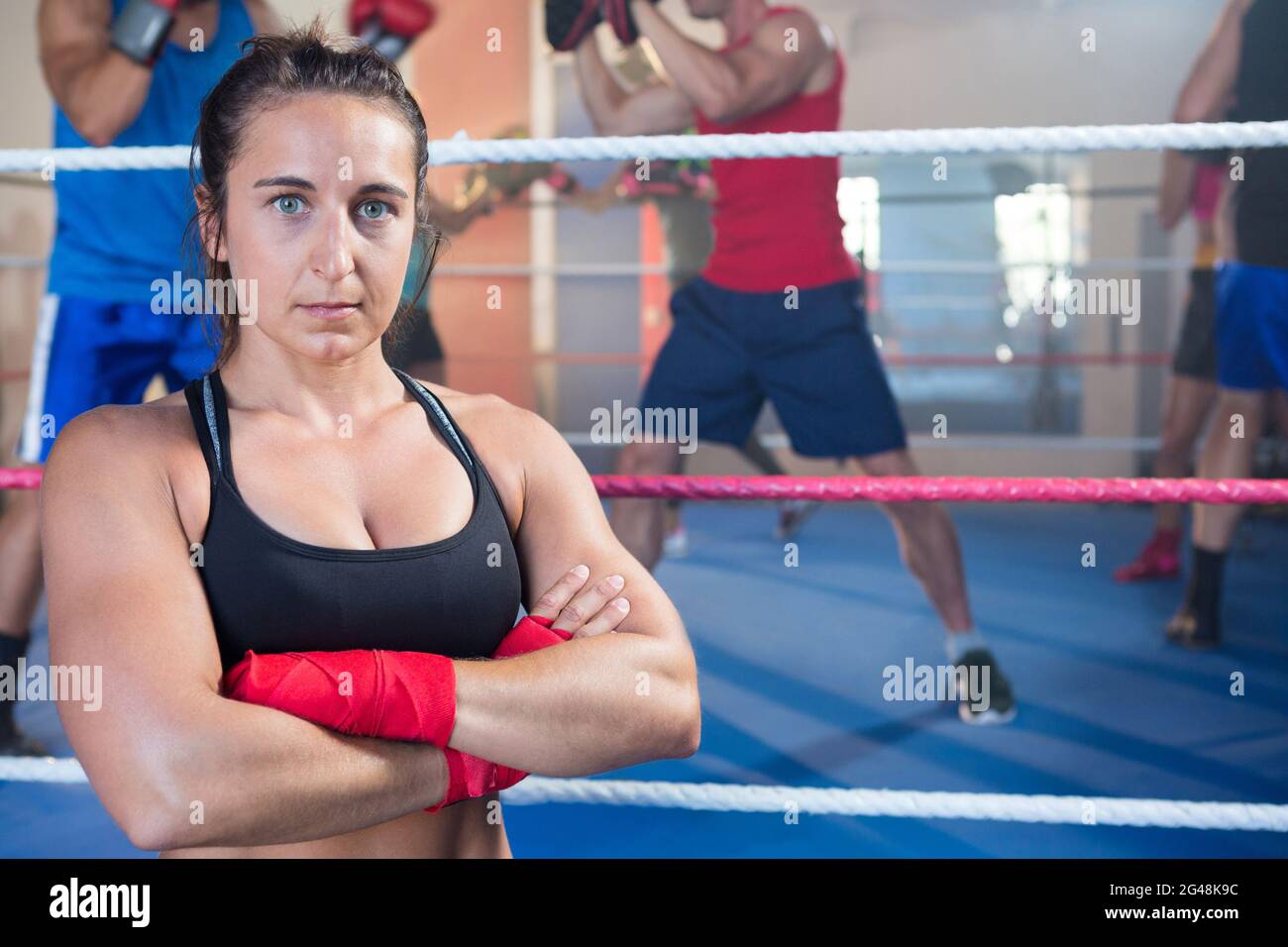 Portrait of confident female boxer standing with arms crossed Stock ...