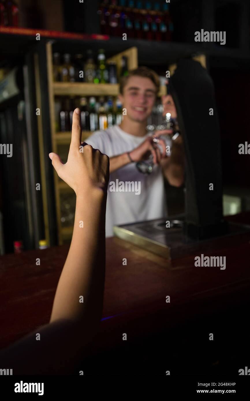 Customer giving placing order to bartender Stock Photo - Alamy