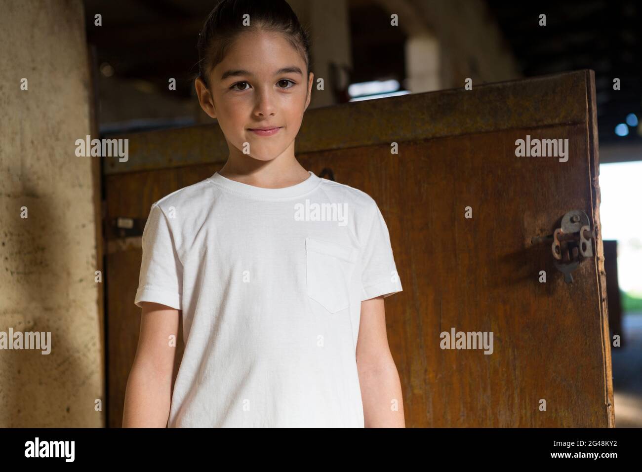 Girl standing in stable Stock Photo - Alamy