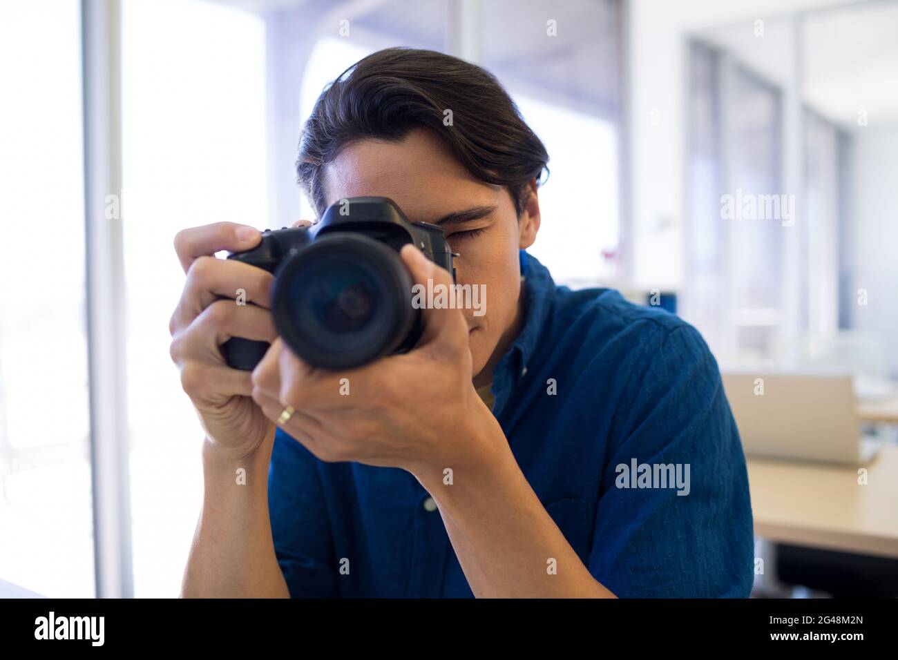 Male executive clicking a picture on digital camera Stock Photo - Alamy