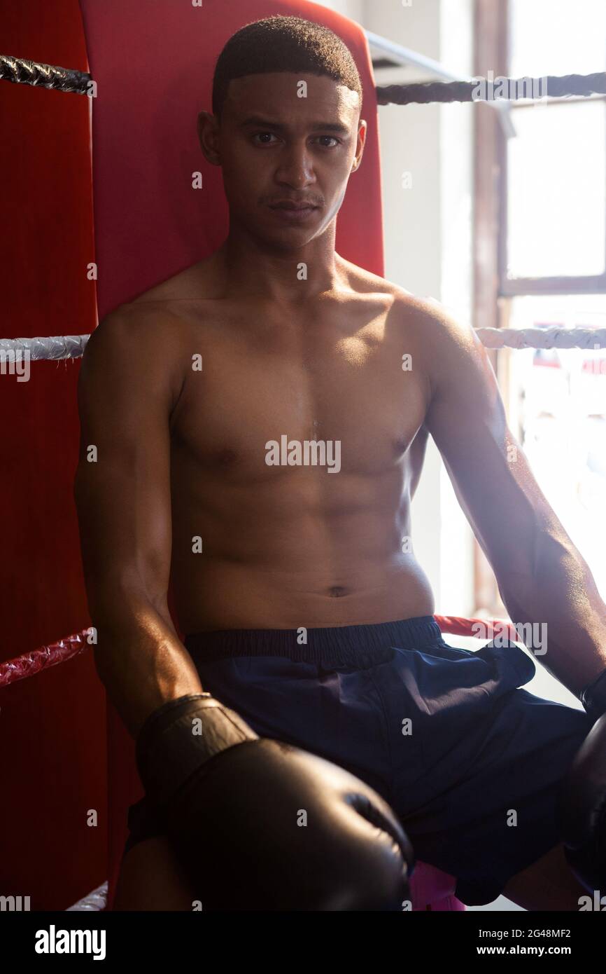 Portrait of confident man sitting in boxing ring Stock Photo - Alamy