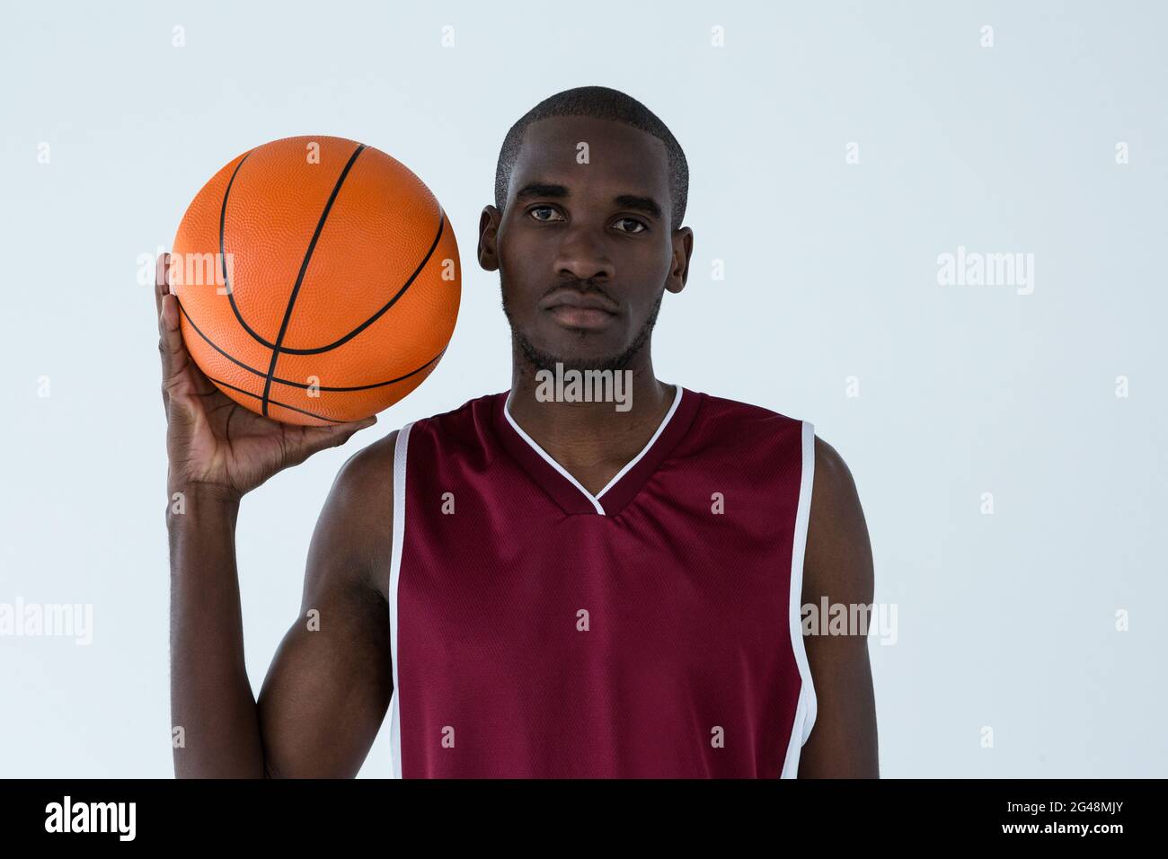 Confident player holding basketball Stock Photo - Alamy
