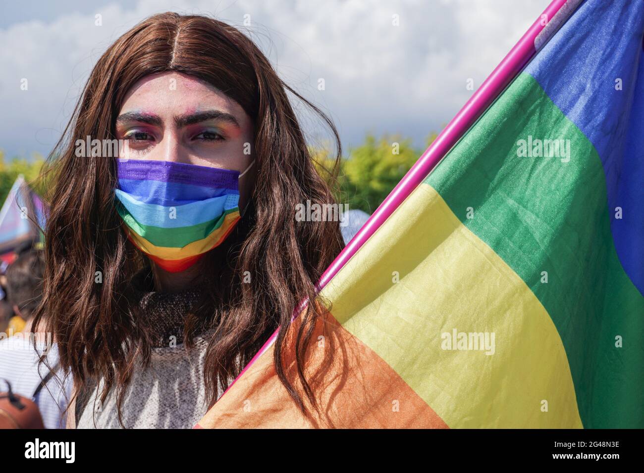 Istanbul, Turkey. 19th June, 2021. An activist holds a LGBTQ flag ...