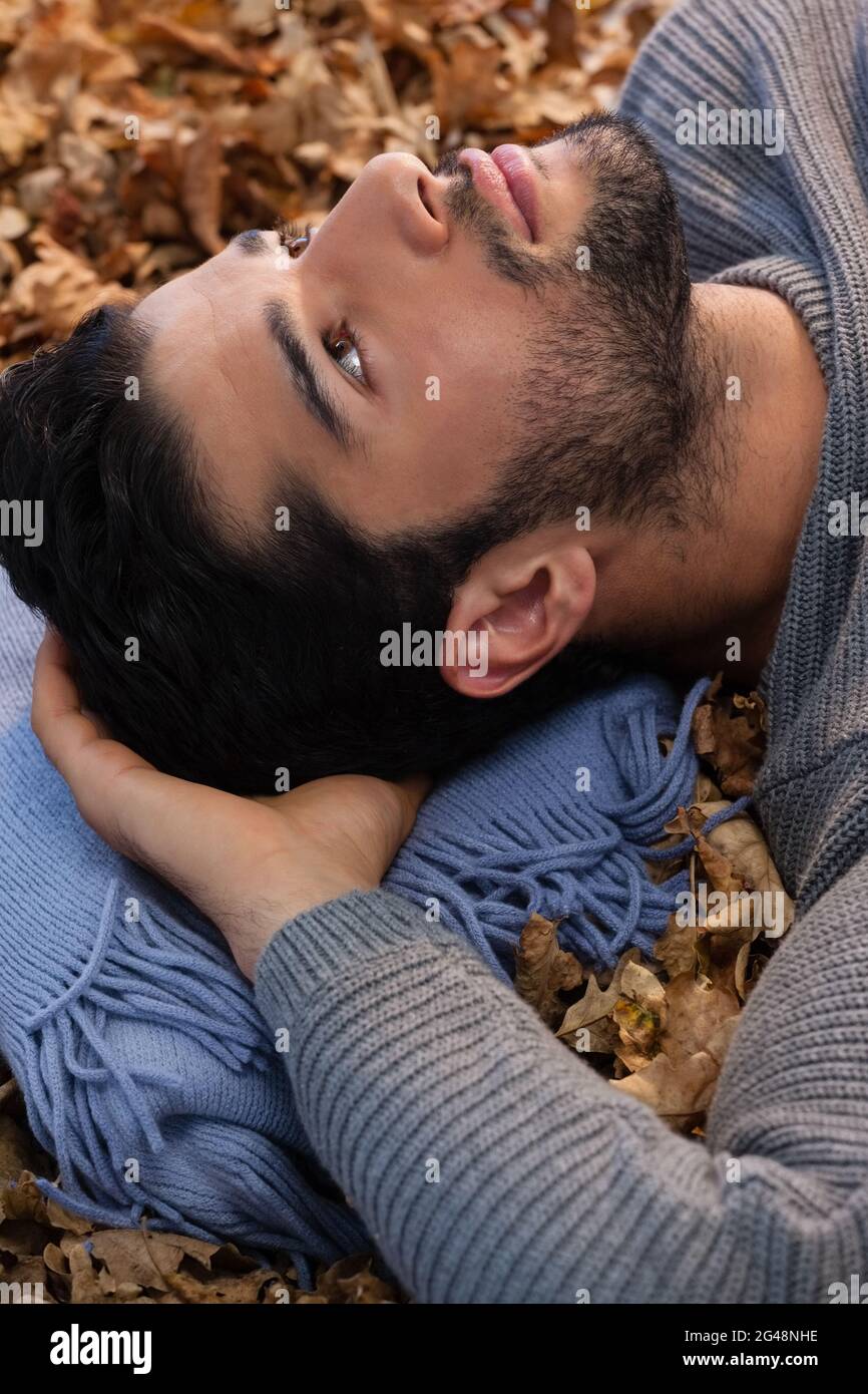 Overhead of man lying on autumn leaves Stock Photo - Alamy