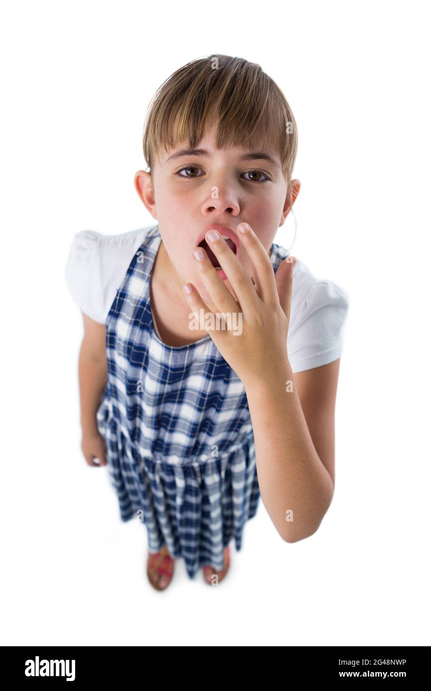 Cute girl yawing on white background Stock Photo - Alamy