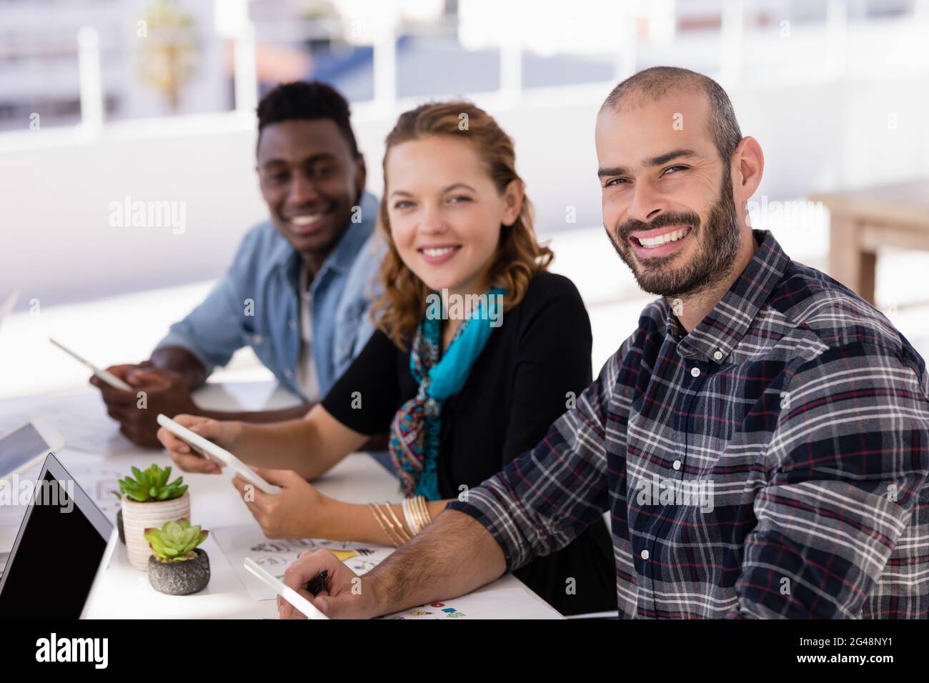 Happy executives using digital table in conference room Stock Photo - Alamy