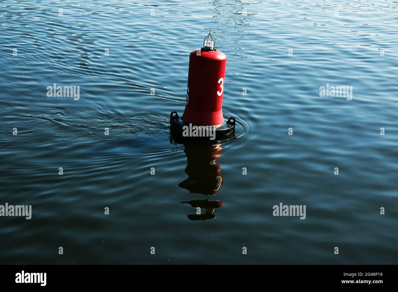 Floating red navigational buoy on blue water of Dnipro River. Buoy in ...