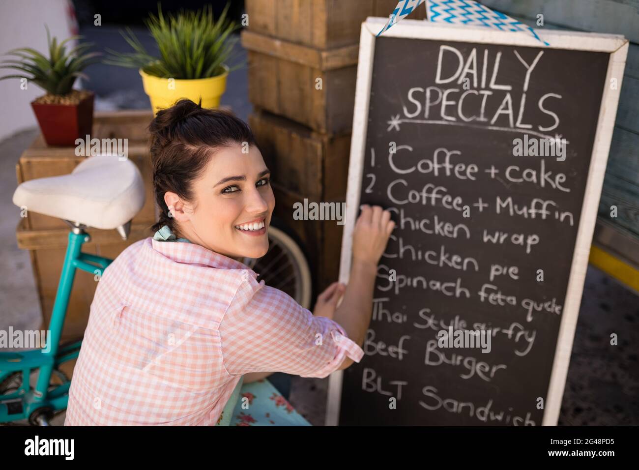 Portrait of waitress writing on slate Stock Photo - Alamy